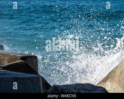 Water splashing against concrete blocks and up through the air Stock ...