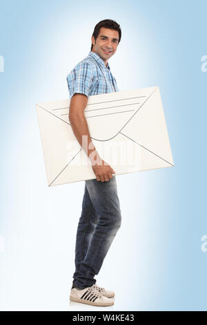 Young man holding envelope with content smile Stock Photo - Alamy