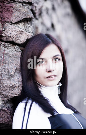 Beautiful young near the wall. Close-up copy space Stock Photo - Alamy