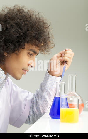 Laboratory testing. Scientist dripping sample into Petri dish at white ...