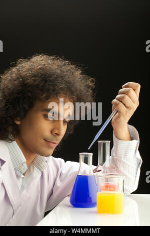 scientist examining jar with liquid sample Stock Photo - Alamy