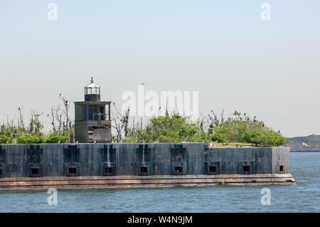 View of a dilapidated wooden lighthouse, on a sea-wall fortified island ...