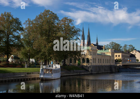 Beautiful view in Uppsala city downtown with high stone wall, trees and ...