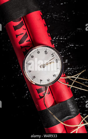 Dynamite bomb with a timer, and a bunch of dynamite on black background ...