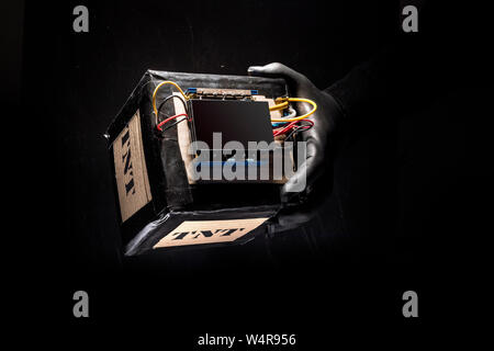 Terrorist is holding home made bomb with cables and remote controled ...