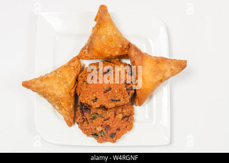 Kerala Vada and Samosa in a white plate Stock Photo - Alamy