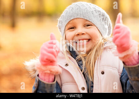 Portrait of happy preteen girl showing thumbs-up when mother talking to pediatrician Stock Photo ...