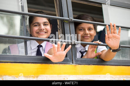 Children waving from school bus windows Stock Photo - Alamy