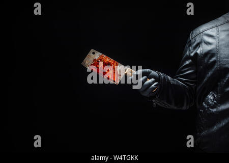 Serial killer's hand with bloody meat cutter and black gloves Stock ...