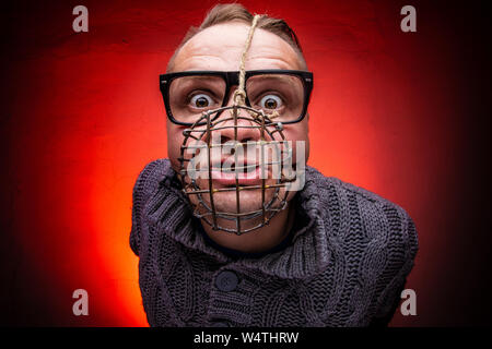 Angry and agressive man with dog muzzle basket shouting Stock Photo - Alamy