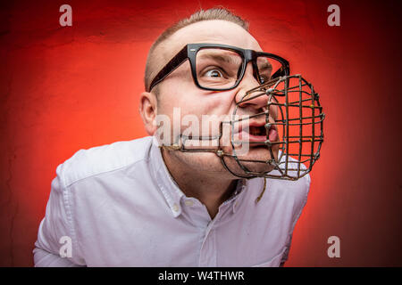 Angry and agressive man with dog muzzle basket shouting Stock Photo - Alamy