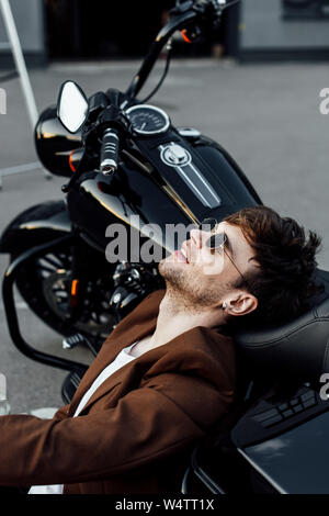 young biker relaxing leaning your motorcycle Stock Photo - Alamy