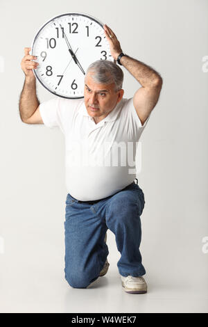 Man holding clock with arms outstretched Stock Photo - Alamy
