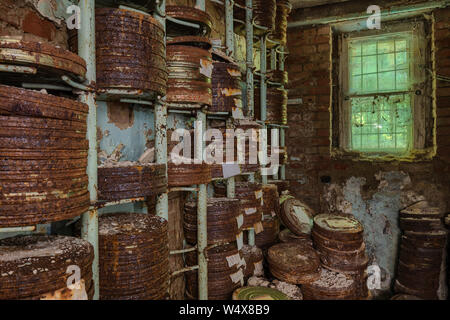 Destroyed from time to time storage room with stored old rusty round ...