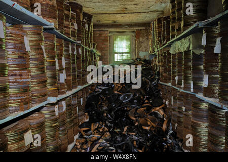 Destroyed from time to time storage room with stored old rusty round ...