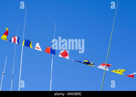 a gray warship fragment decorated with a row of colorful nautical ...