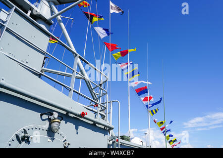 a gray warship fragment decorated with a row of colorful nautical ...