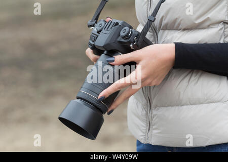 SLR camera hanging around my neck at the photographer Stock Photo - Alamy