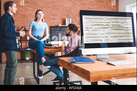 Team of programmers during break in office Stock Photo - Alamy
