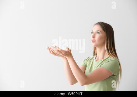 Religious young woman praying on white background Stock Photo - Alamy