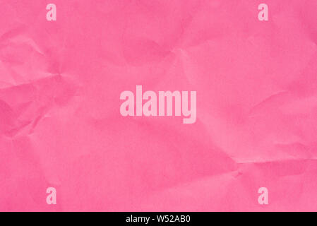pink creased color paper texture background selective focus closeup ...