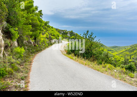 Greece, Zakynthos, Twisting mountain road down to the coast through ...