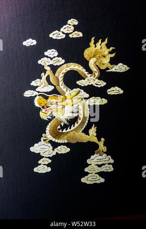 A painting made of fish skins by the Hezhen People is on display at a ...