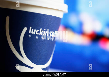 --FILE--A customer shows a cup of Luckin Coffee at a store of China's ...