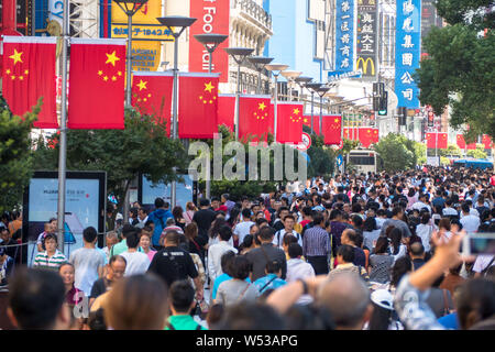 Chinese tourists overcrowd the Nanjing Road pedestrian shopping street ...