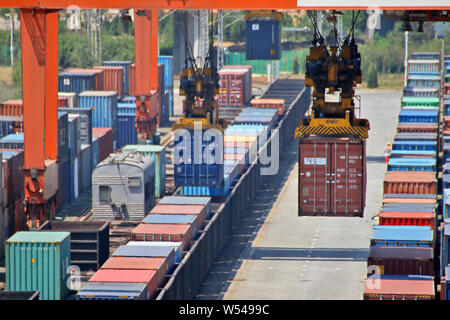 --FILE--Containers to be loaded in a freight train are seen at a ...