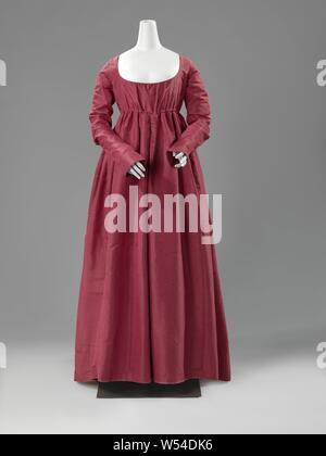 A long narrow trail in the middle of a forest surrounded by dense trees ...