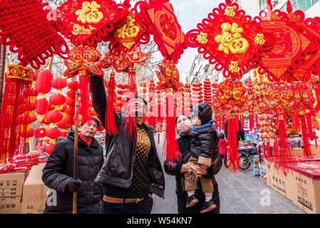 Residents shop for festive decorations at a commodity market in Huai'an ...