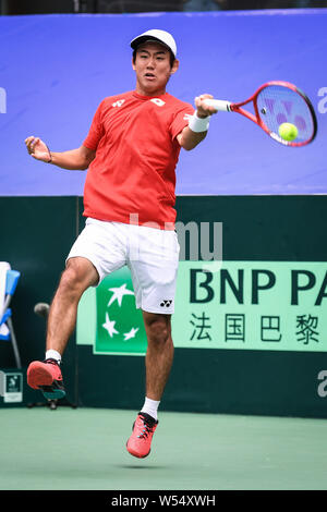 Li Zhe of China returns a shot to Mischa Zverev of Germany in their ...