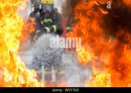 Firefighters distinguish a fire during the fire and rescue drill with ...