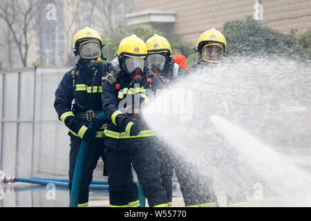 Firefighters distinguish a fire during the fire and rescue drill with ...