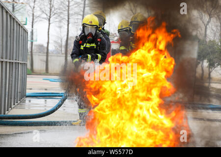 Firefighters distinguish a fire during the fire and rescue drill with ...