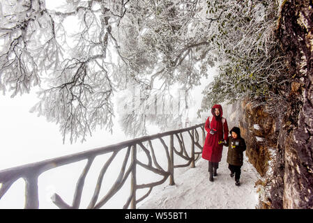 Tourists visit the snow-covered Tianmen Mountain in Zhangjiajie city ...