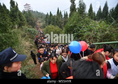 Local residents crowd the Fenghuang mountain during the Dazhou Yuanjiu ...