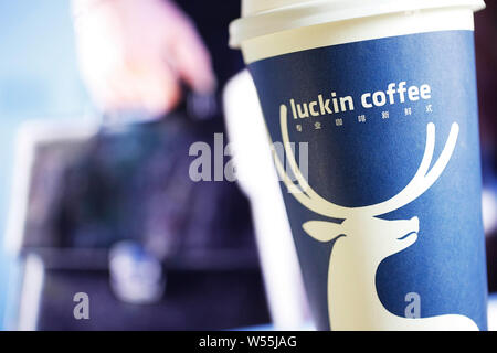 --FILE--A customer shows a cup of Luckin Coffee at a store of China's ...