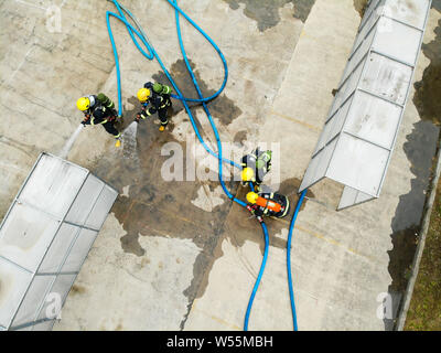 Firefighters distinguish a fire during the fire and rescue drill with ...