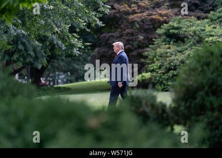 President Donald Trump walks to board Marine One before departing from ...