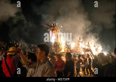 Chinese entertainers perform a fire dragon dance to celebrate the Mid ...