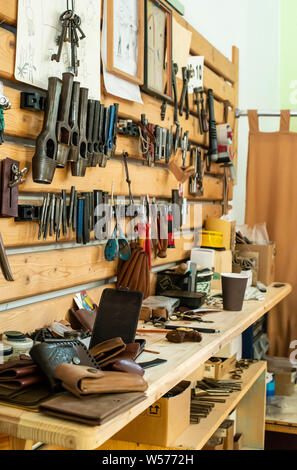 Hammer on shelf and leather in workshop Stock Photo - Alamy
