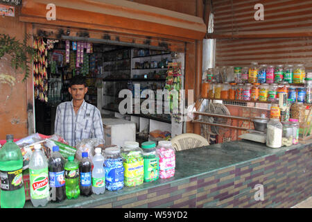 shopkeeper selling grocery items in his shop Stock Photo - Alamy