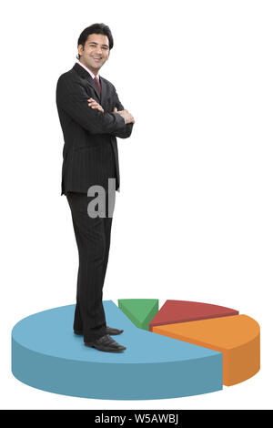 The businessman standing on pie chart in business concept Stock Photo ...