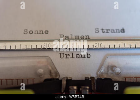 Typewriter with a leaf and the words sun, Palm tree, beach and vacation ...