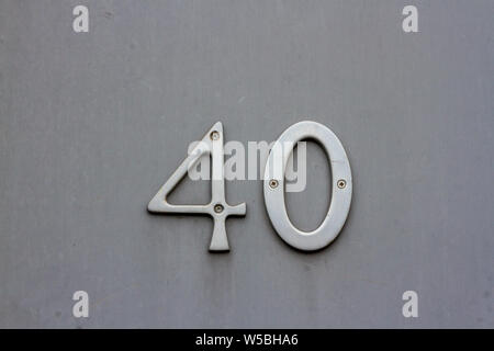House number with the in metal digits on a wooden front door Stock ...