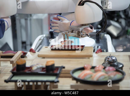 Robotic arm preparing japanese food a dish of sushi Stock Photo - Alamy