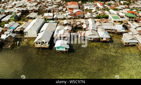 Poor district slums with wooden houses over water, Cebu city ...