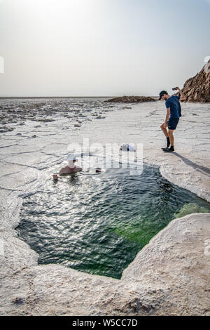 Water of Lake Karum, visible through a hole in the salt flat, Danakil ...